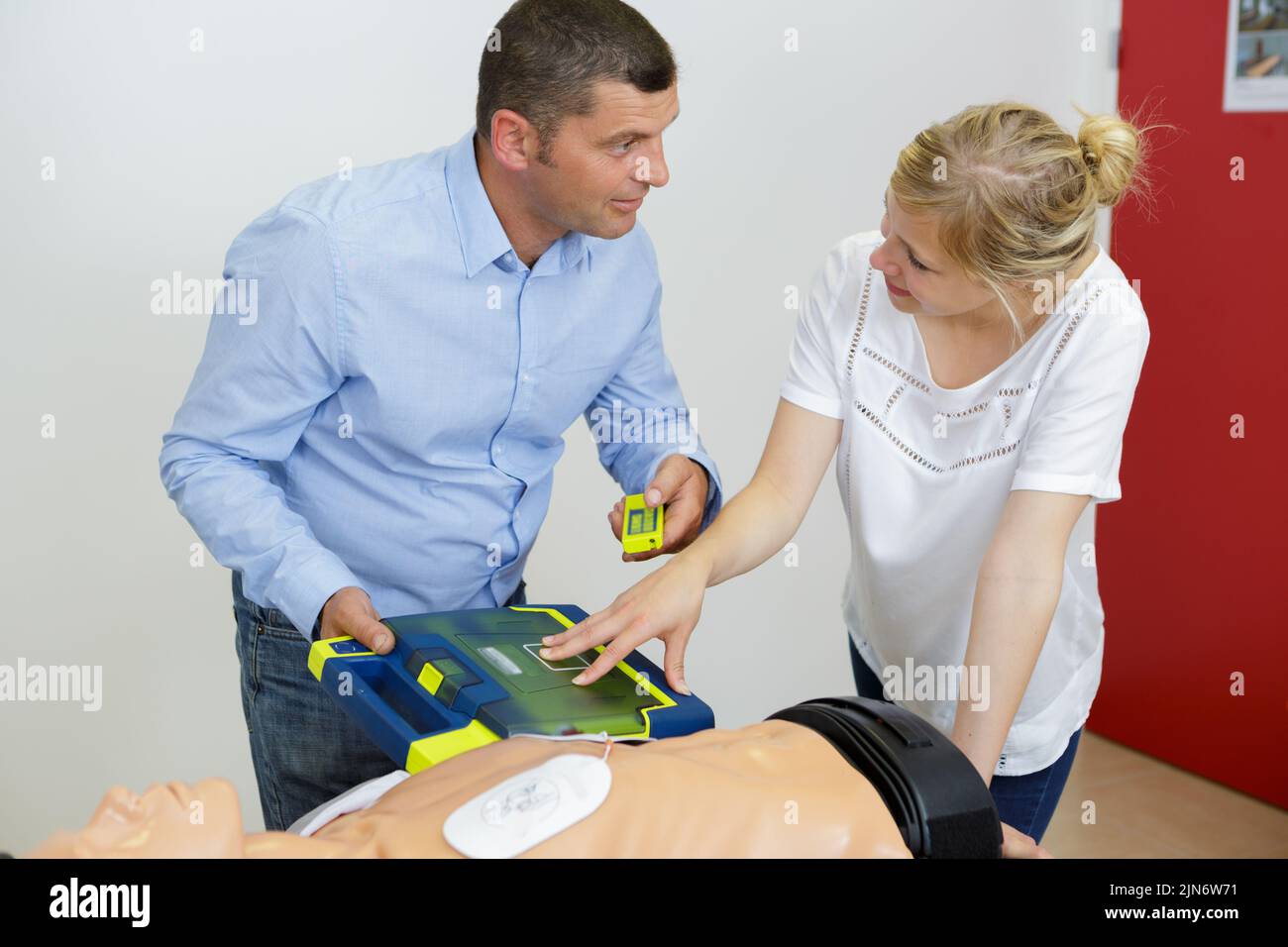team of coworkers and first aid training Stock Photo - Alamy
