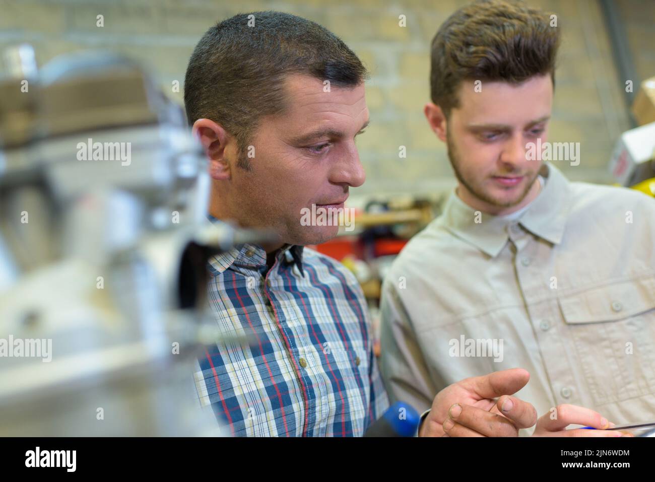 Two men hand something hi-res stock photography and images - Alamy
