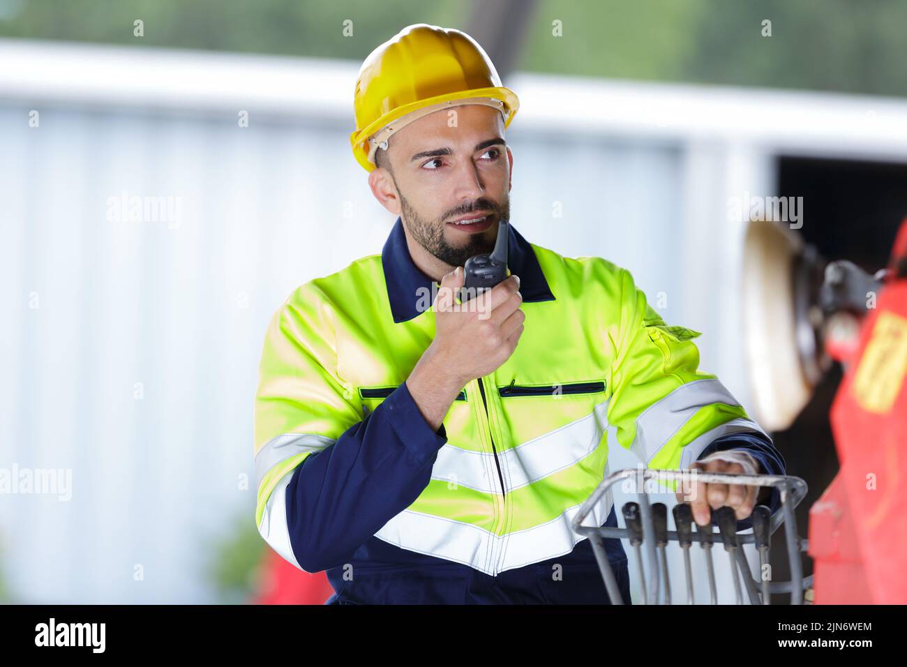 male worker using walkie-talkie in shipping yard Stock Photo - Alamy