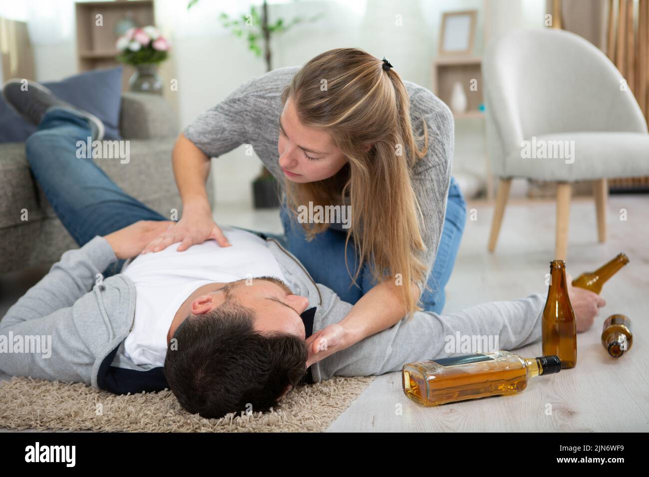 man collapsed in the home after drinking alcohol Stock Photo - Alamy