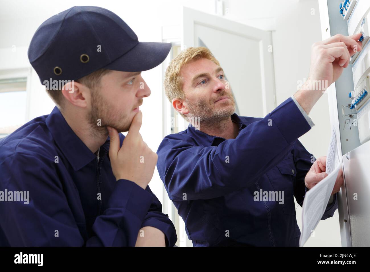 young electrician learning the electrical panel Stock Photo - Alamy