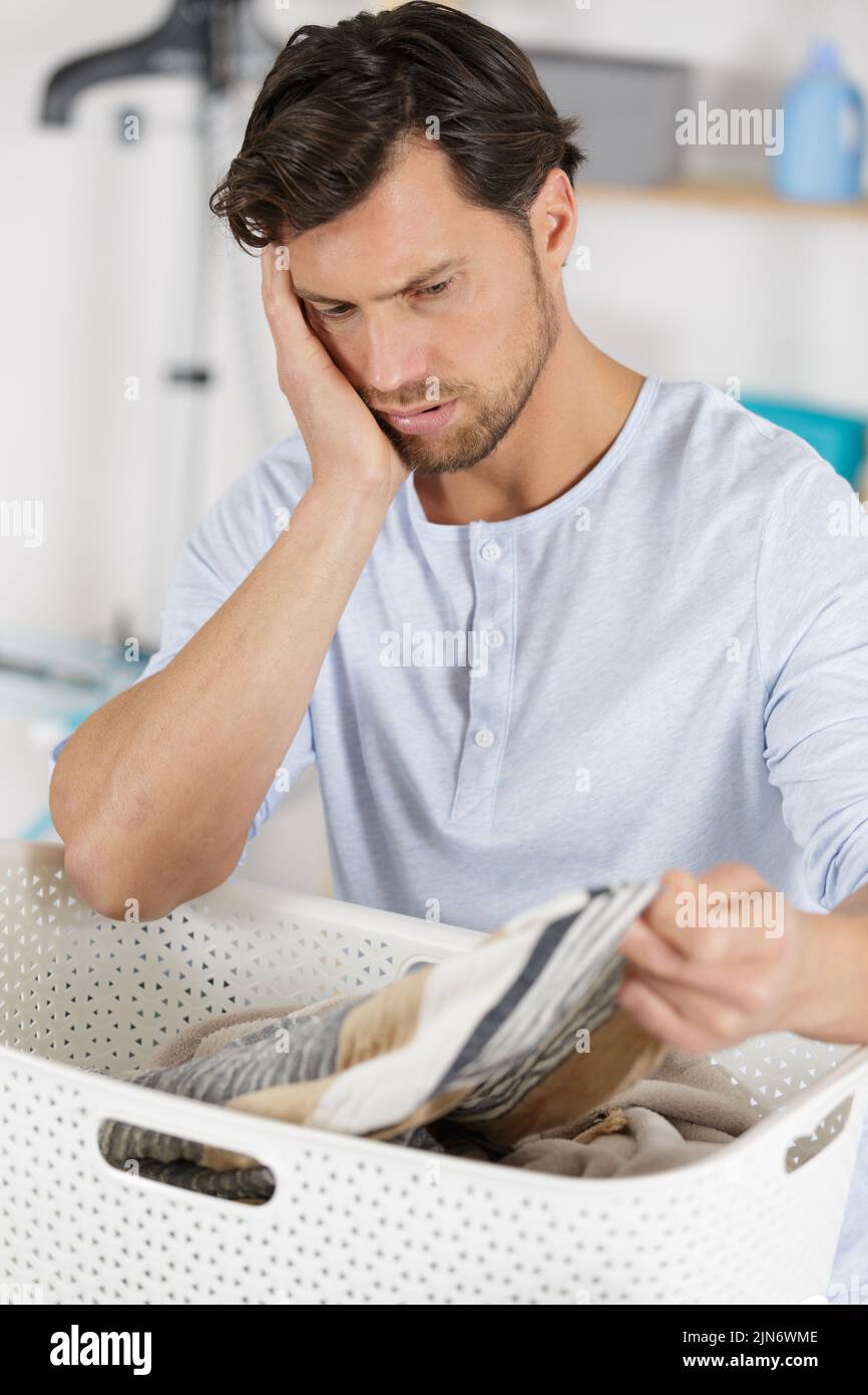 worried husband man doing laundry at home Stock Photo - Alamy