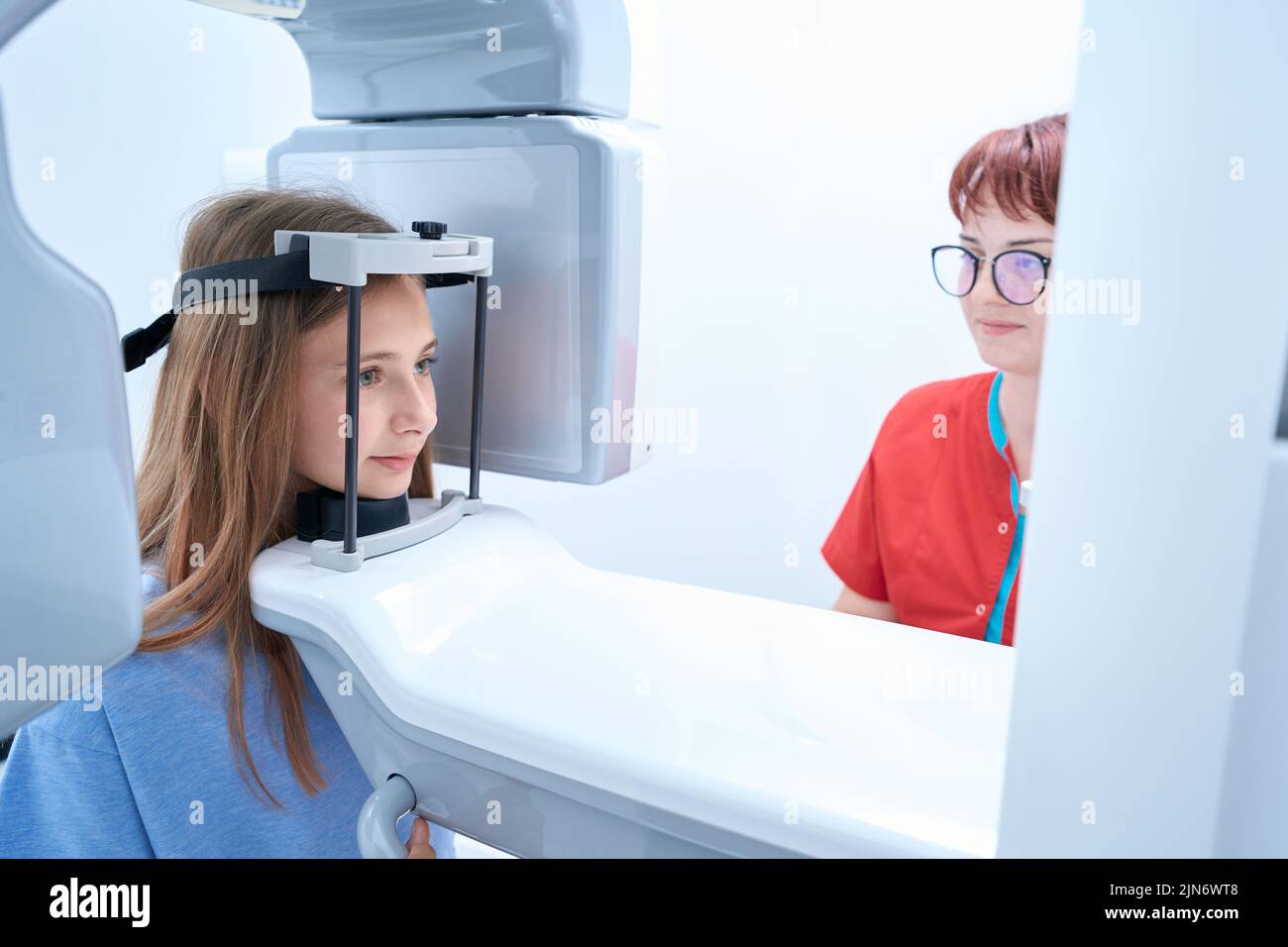 Young lady getting digital panoramic x-ray in presence of doctor Stock ...