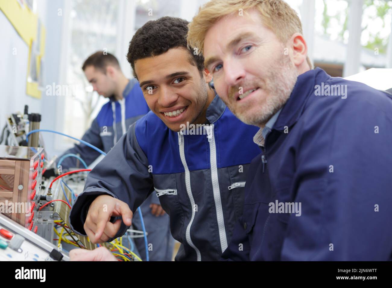 two electrician workers at wiring cable and light switch Stock Photo ...