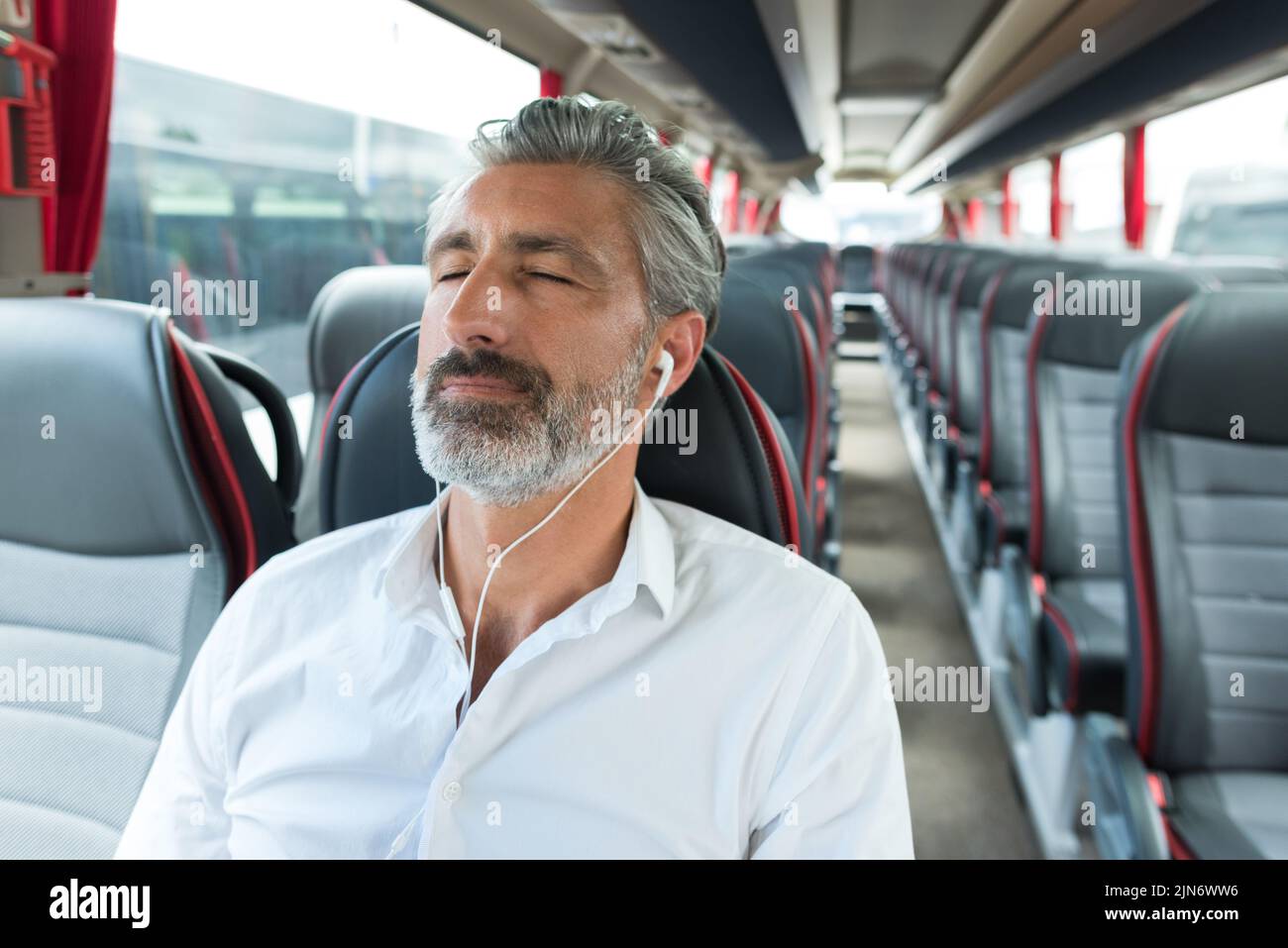 man sleeping in travel bus Stock Photo - Alamy