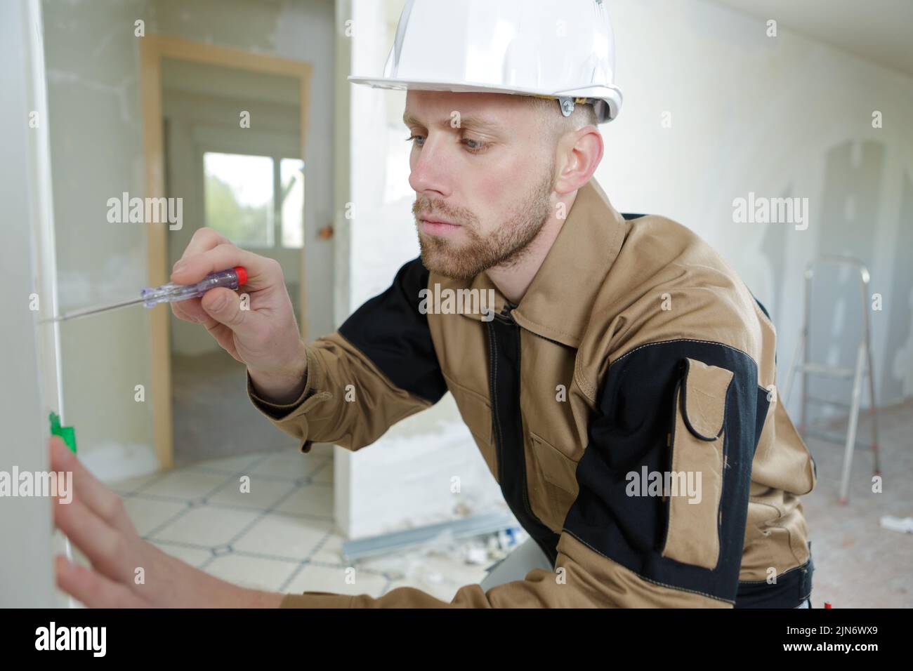 builder screws in a wall Stock Photo - Alamy