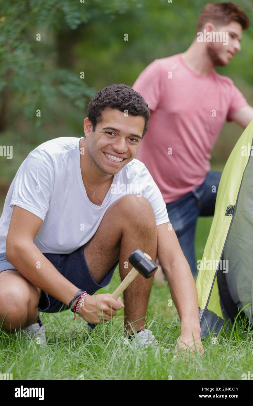 happy young men camping in nature Stock Photo - Alamy