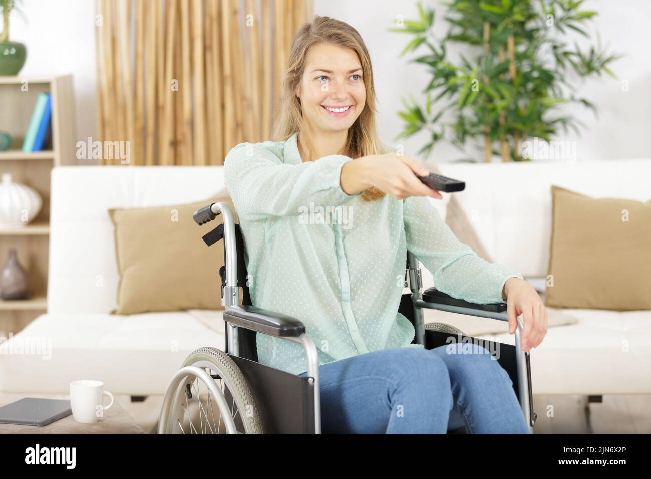 Woman pressing remote control hi-res stock photography and images - Alamy