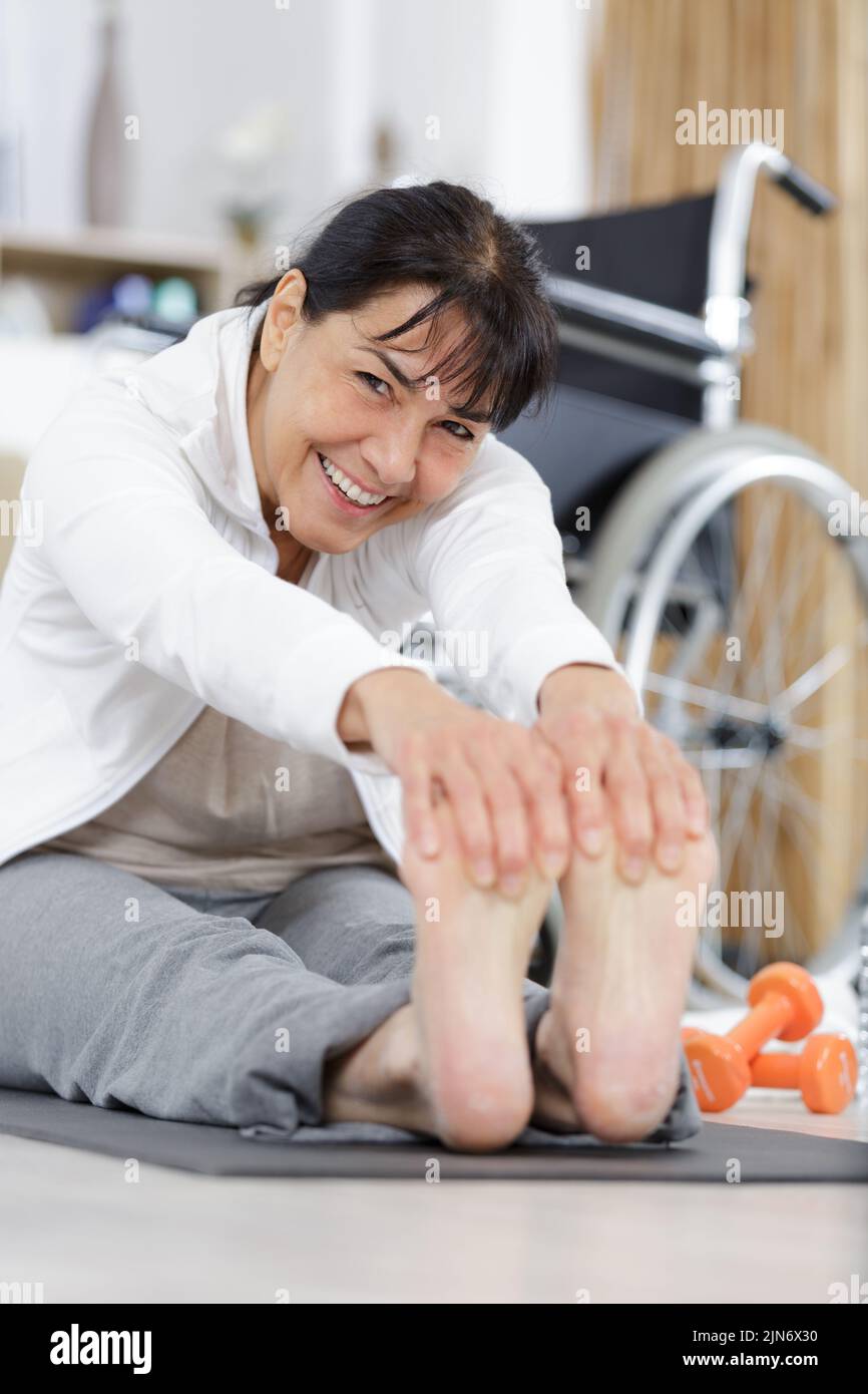 senior stretching legs in studio Stock Photo - Alamy