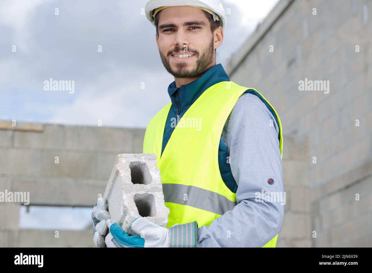 asian builder man holding concrete blocks for house building Stock ...