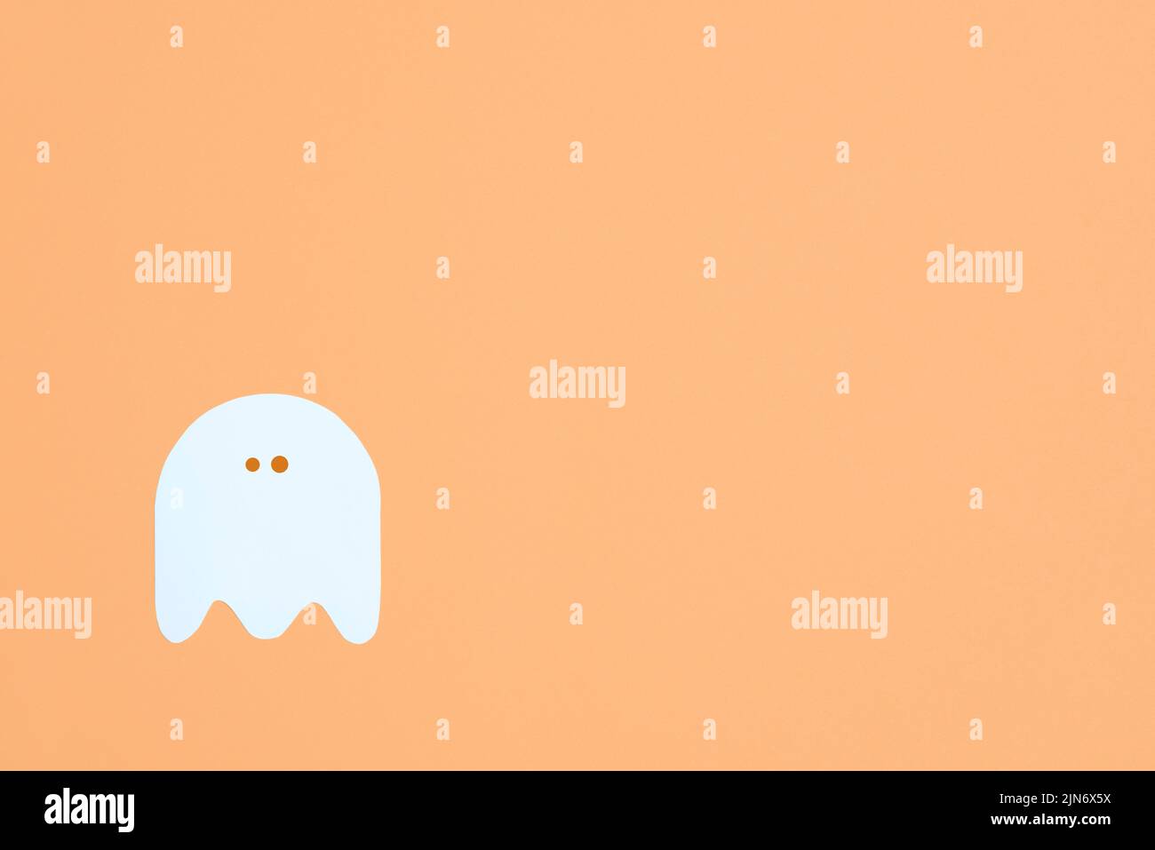 Minimalist halloween design, white cute ghost isolated on pastel orange ...