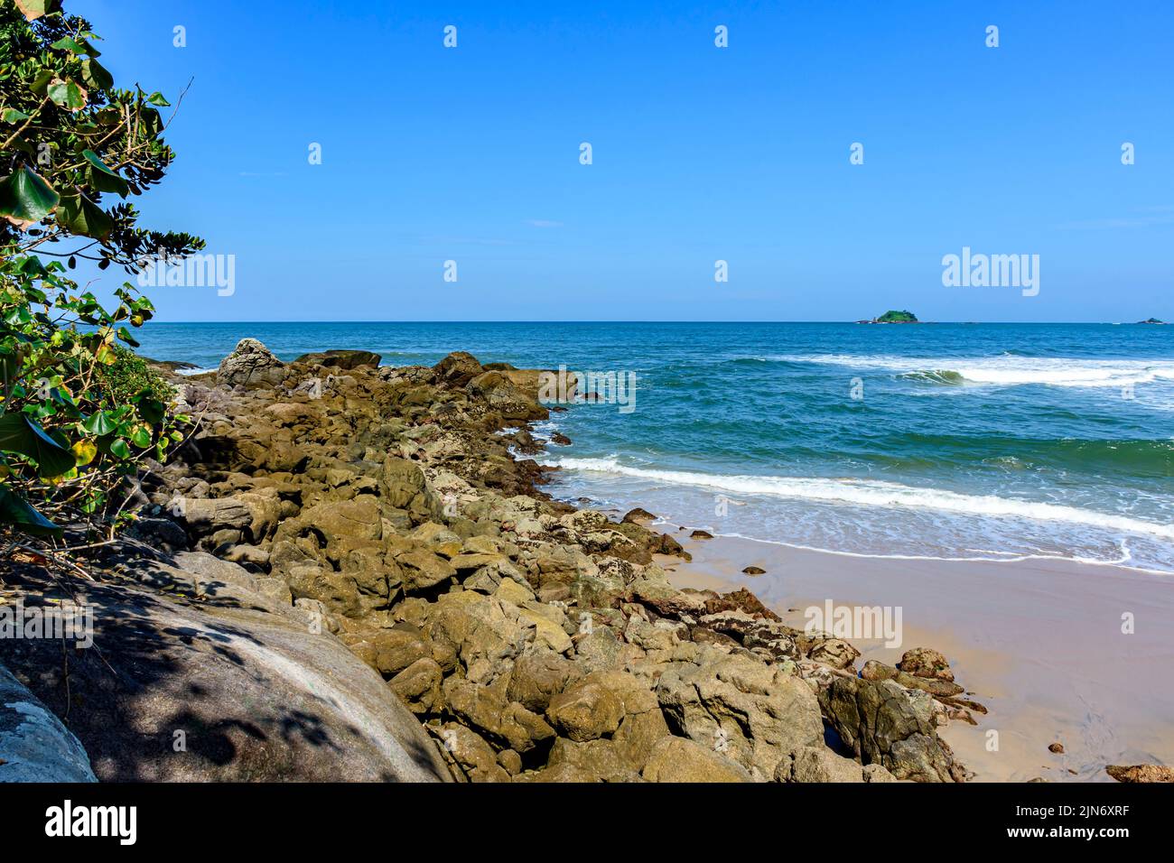 Stones advancing into the sea on a paradise beach in Bertioga on the ...