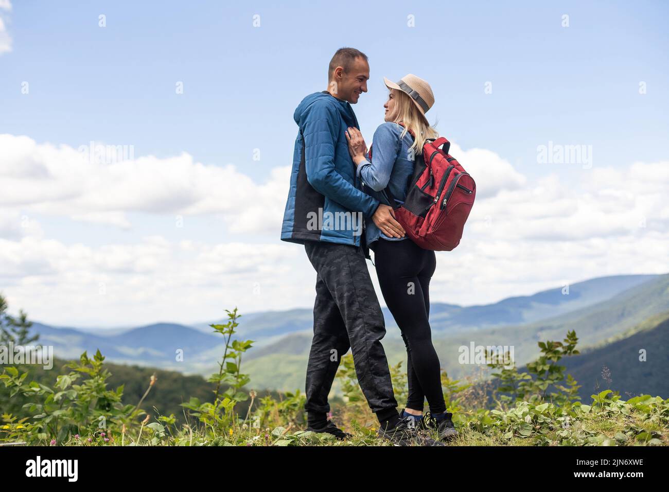 Portrait of beautiful young couple enjoying nature at mountain peak Stock Photo - Alamy