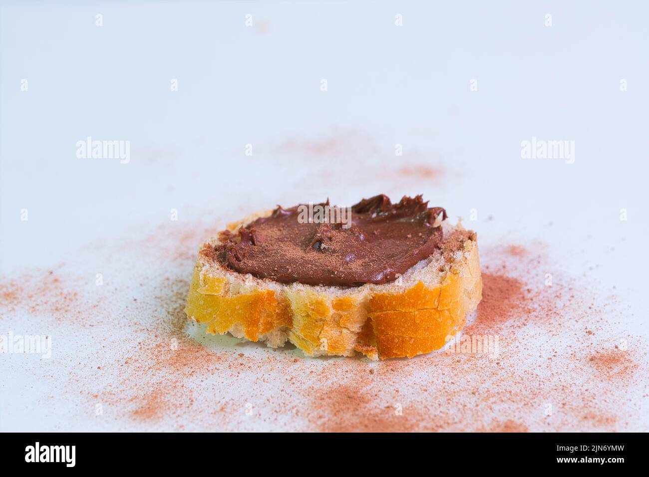 a slice of white bread with nougat chocolate cream, dusted with cocoa ...