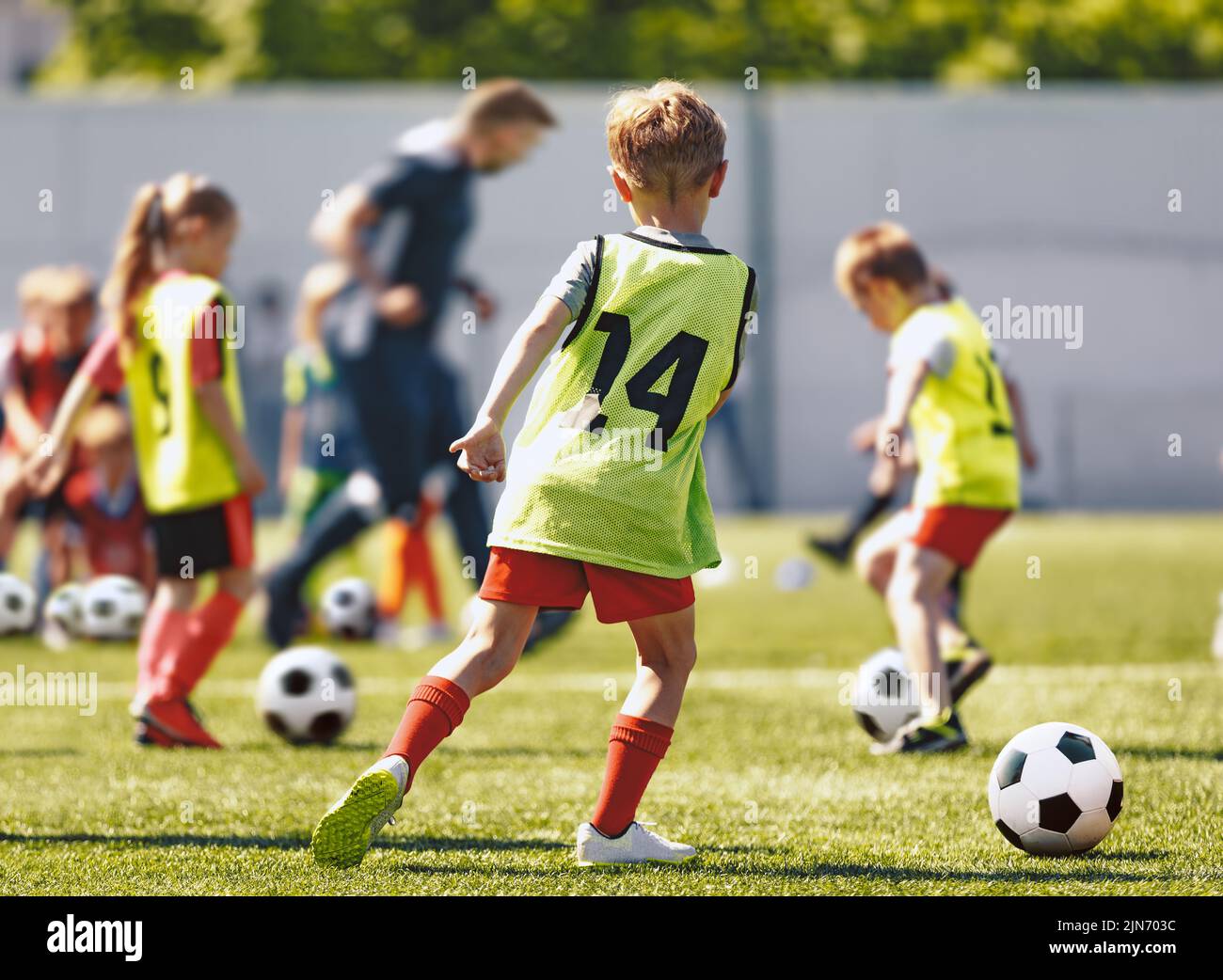 School Children Play Soccer Football Training Game With Coach. Kids ...