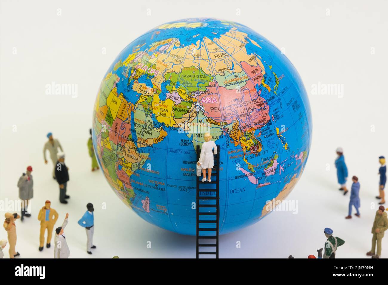 world globe, a doctor on a ladder examines the earth , many people are ...