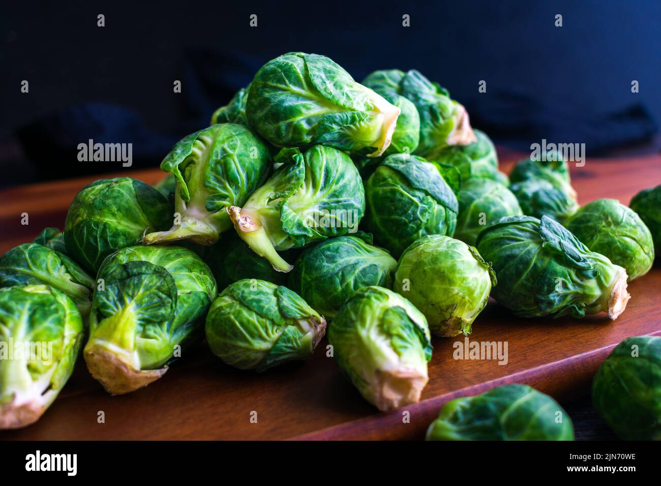 Fresh Brussels Sprouts Piled on a Wood Cutting Board: A pile of ...