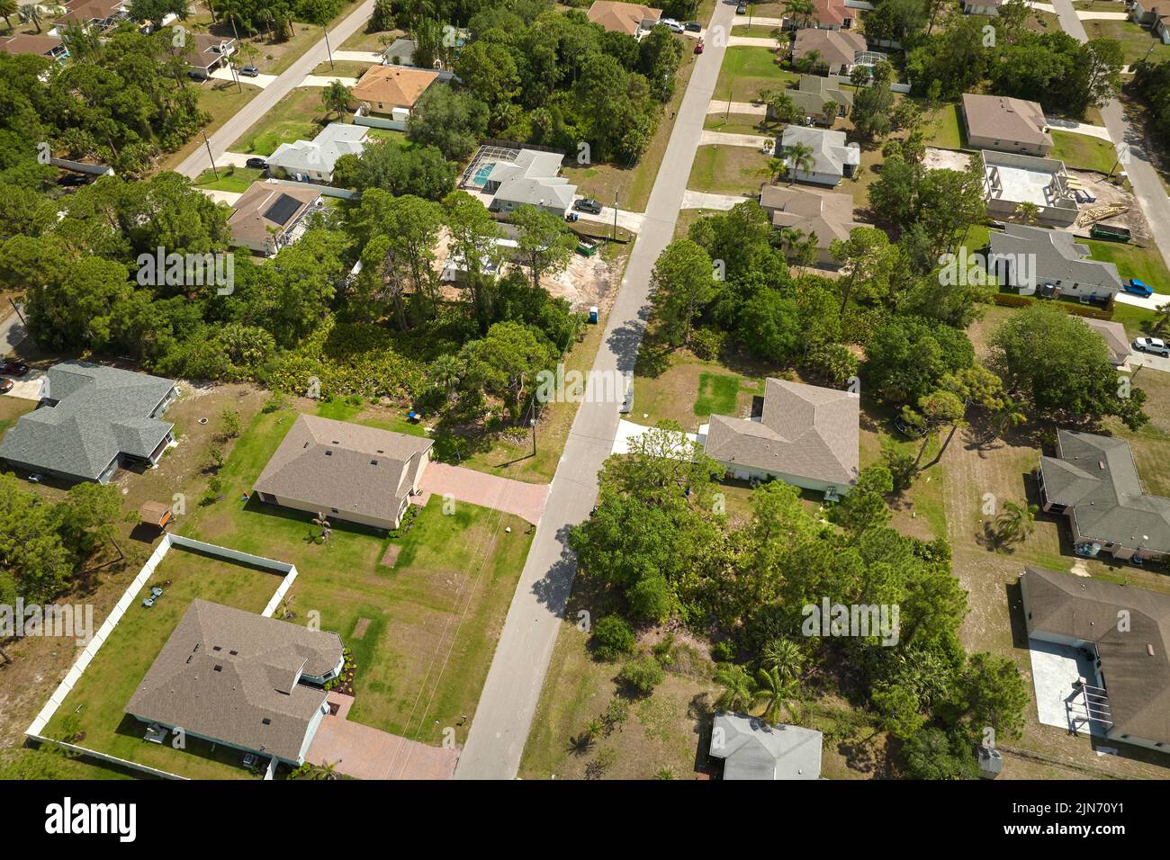 Aerial landscape view of suburban private houses between green palm ...