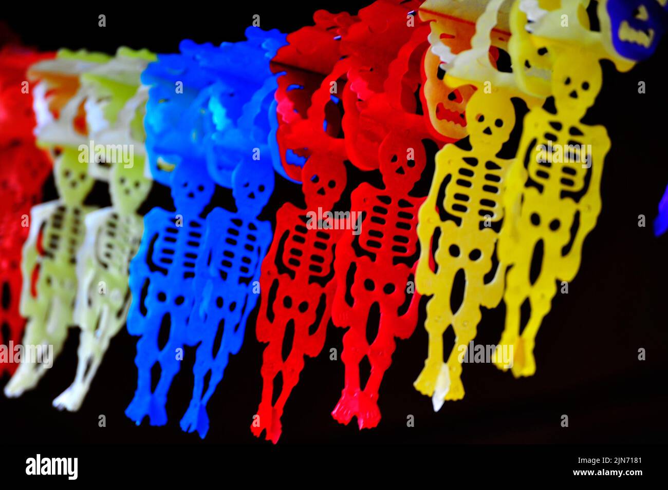 An elaborate and colorful sequence of skeleton-shaped decorations on a ...