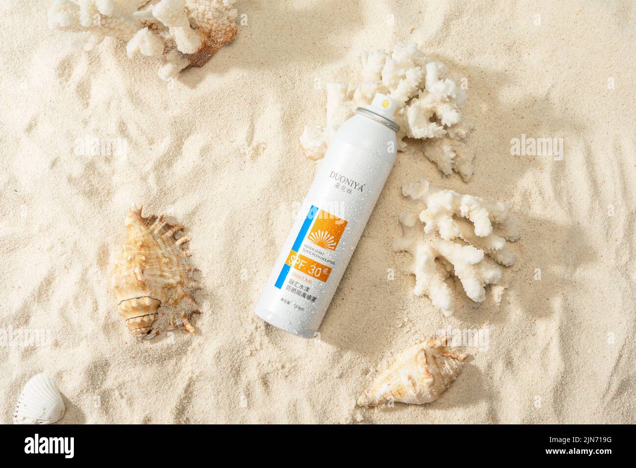 A sunscreen protection on white sand and sea shell Stock Photo - Alamy