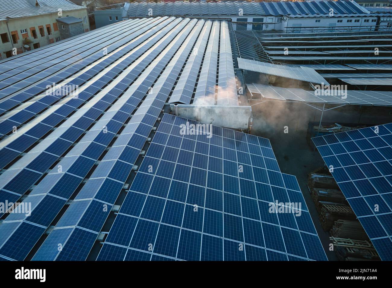 Aerial view of blue photovoltaic solar panels mounted on industrial ...