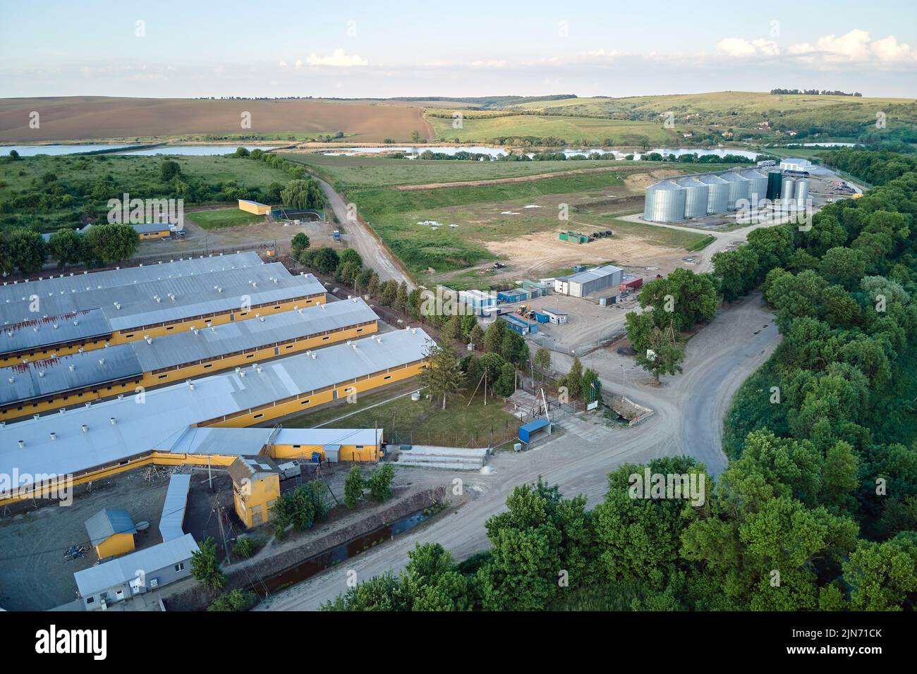 Aerial view of cattle farm buildings between green farmlands Stock ...