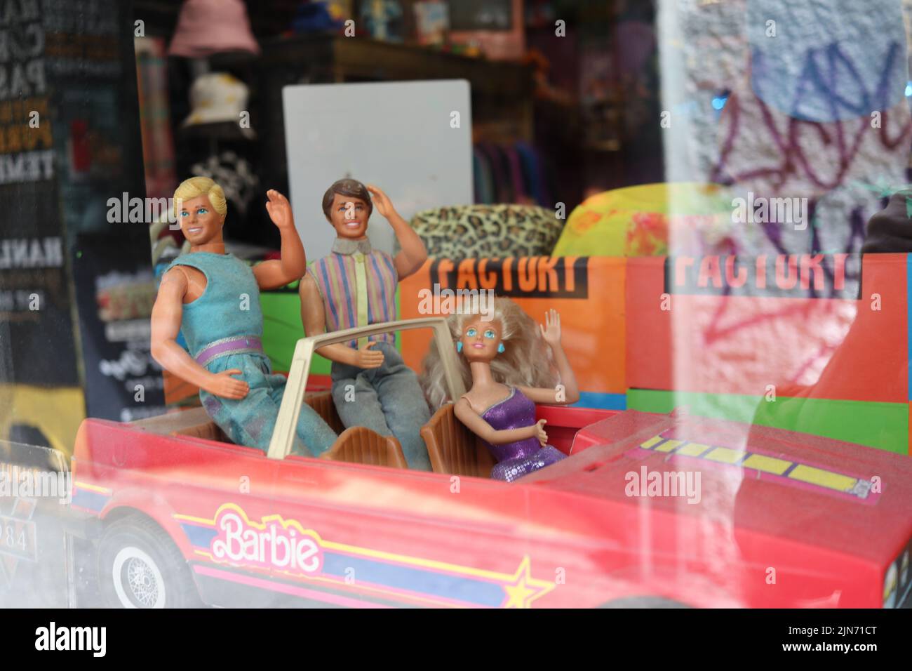 A toy car with dolls through a shop window Stock Photo - Alamy