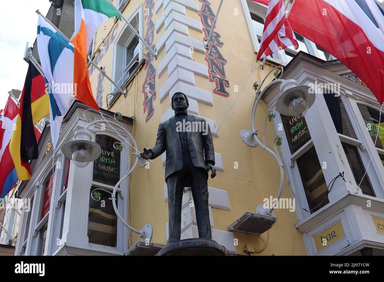 The statue in Temple Bar, Dublin Ireland with national flags Stock ...