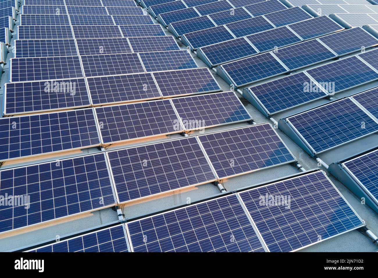 Aerial view of blue photovoltaic solar panels mounted on industrial ...