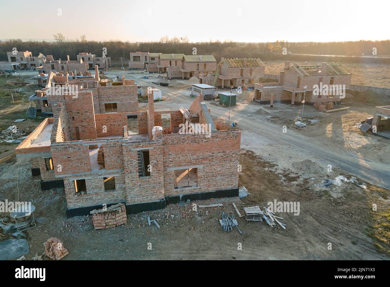 Aerial view of new homes with brick framework walls under construction ...