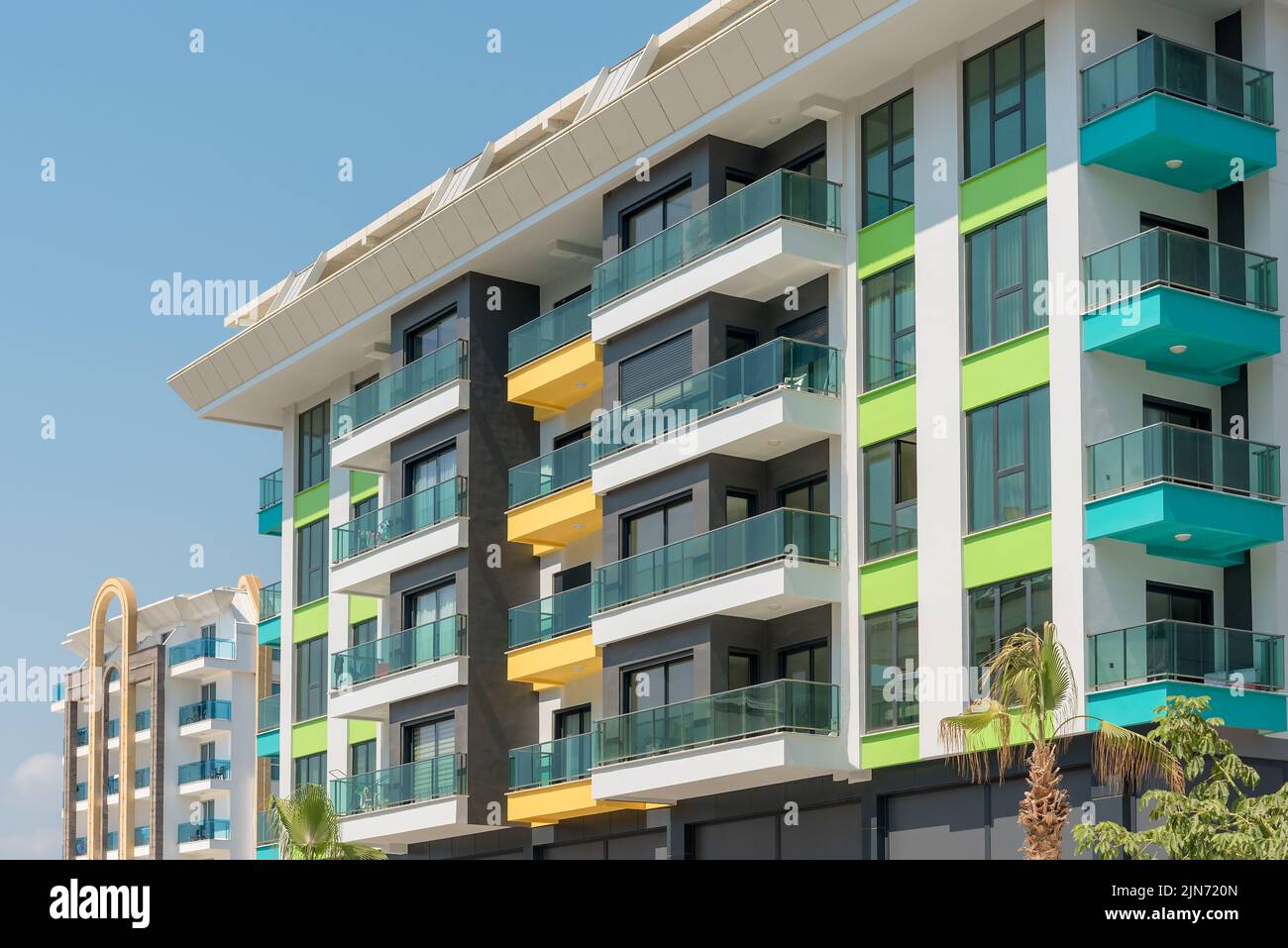 Modern freshly built apartment buildings on a sunny day with blue sky ...