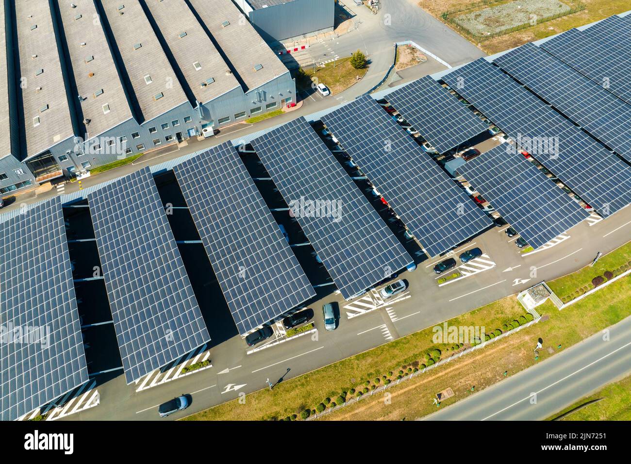Aerial view of solar panels installed over parking lot with parked cars ...