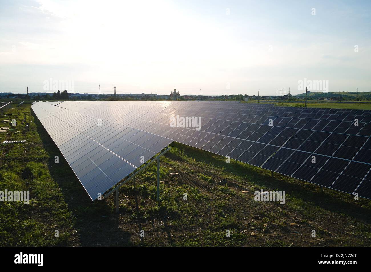 Aerial view of solar power plant on green field. Electric farm with ...