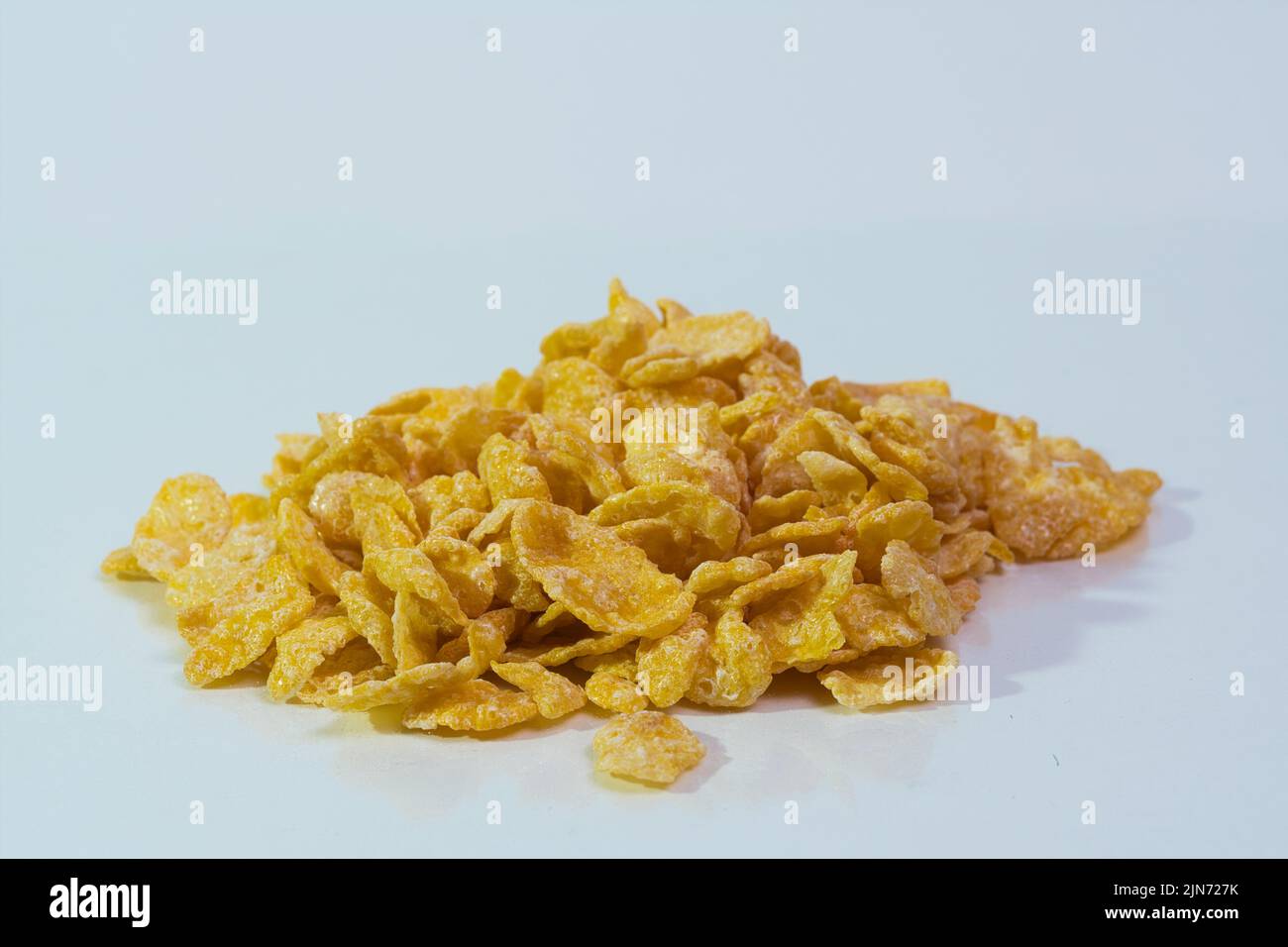 a heap of sugared cornflakes on a light background Stock Photo - Alamy