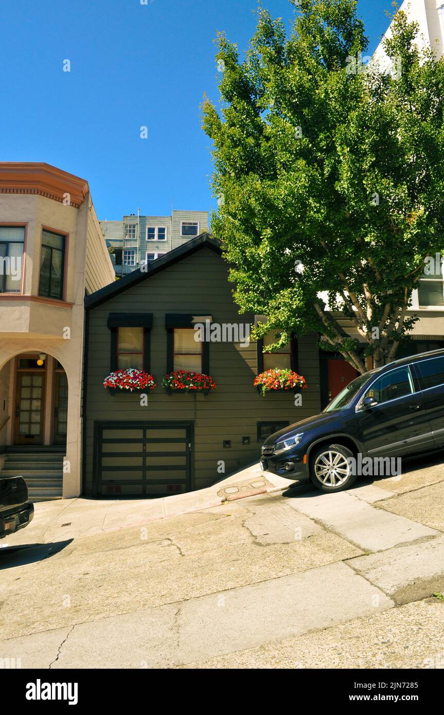 Car parked on steet streets of San Francisco. House on a steep hill ...