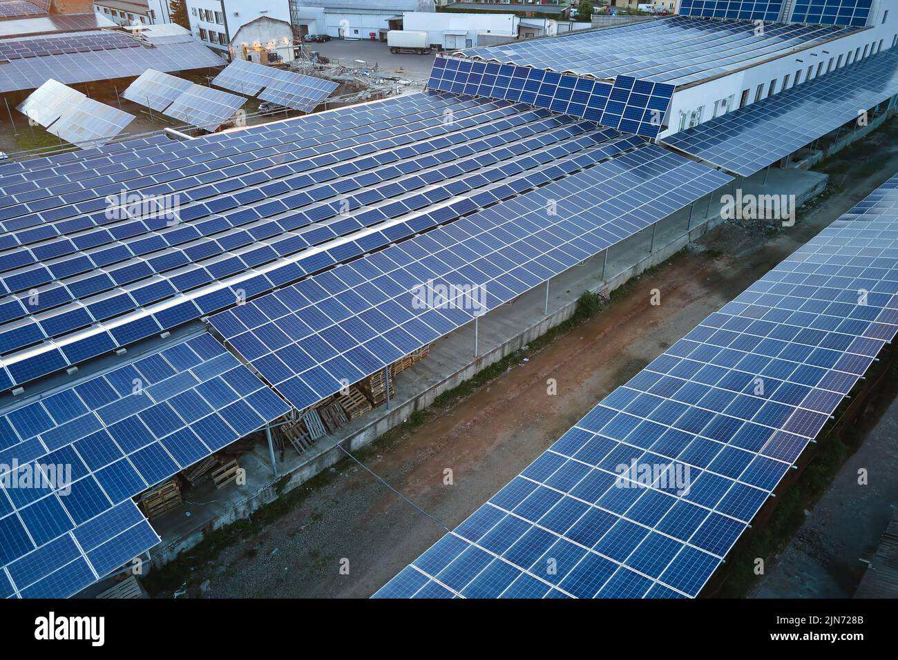 Aerial view of solar power plant with blue photovoltaic panels mounted ...