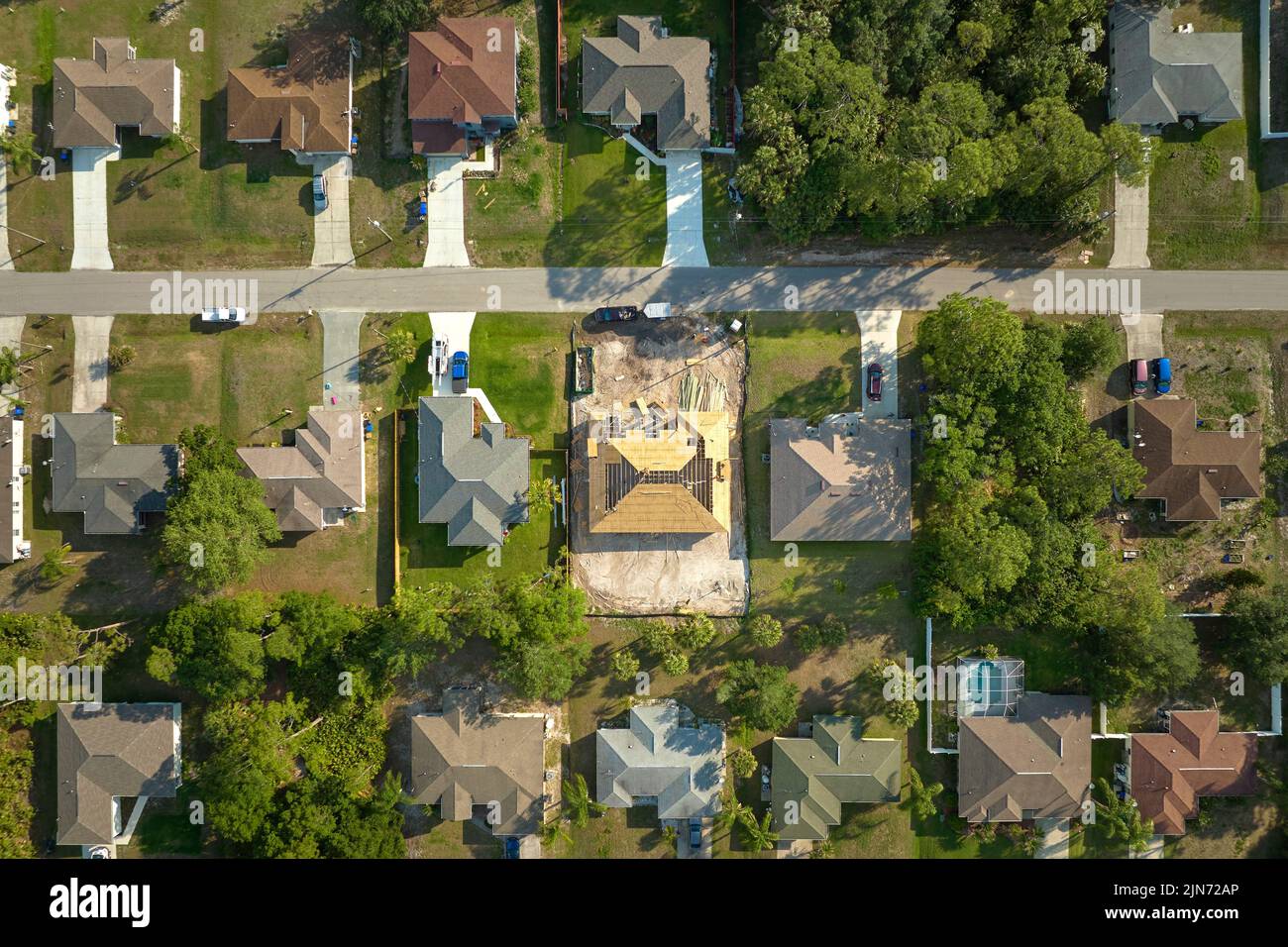 Aerial view of suburban private house wit wooden roof frame under ...