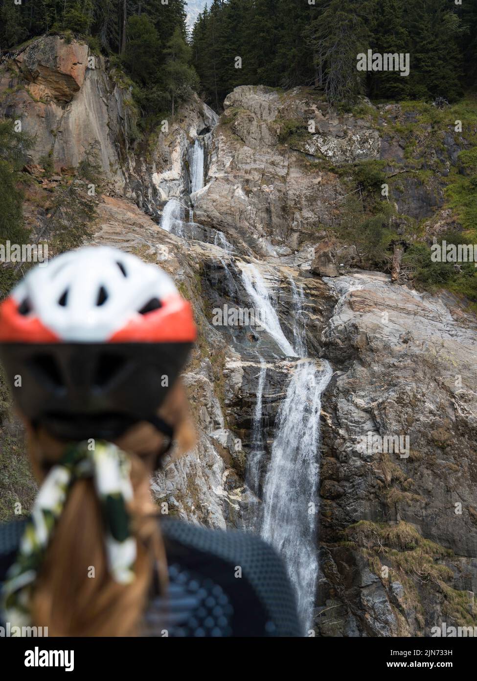 A vertical shot of a female hiking in the mountains Stock Photo - Alamy