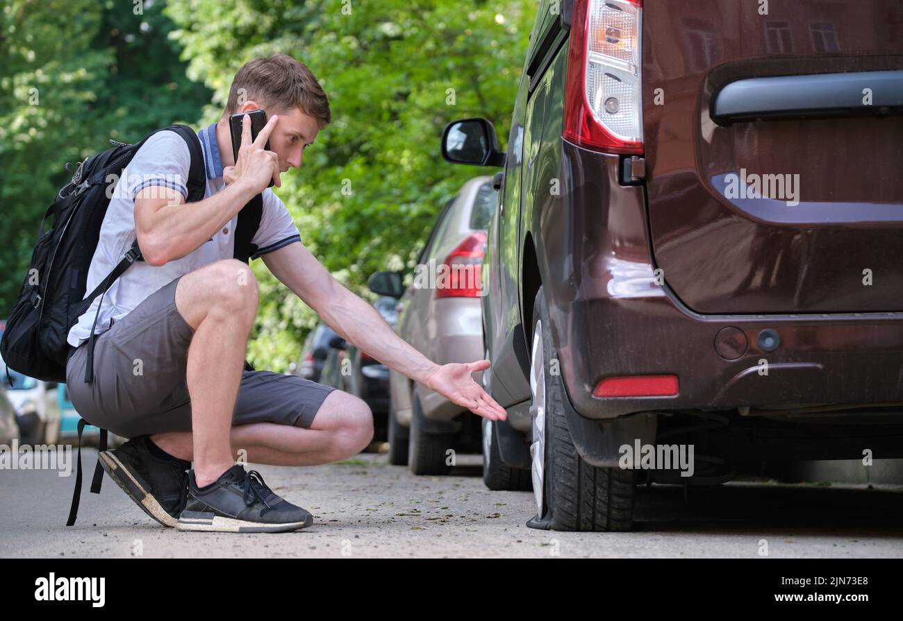 Driver calling road service for assistance having vehicle trouble with ...