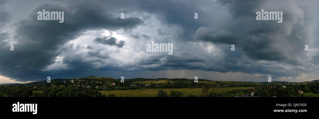 Landscape of dark clouds forming on stormy sky during thunderstorm over ...