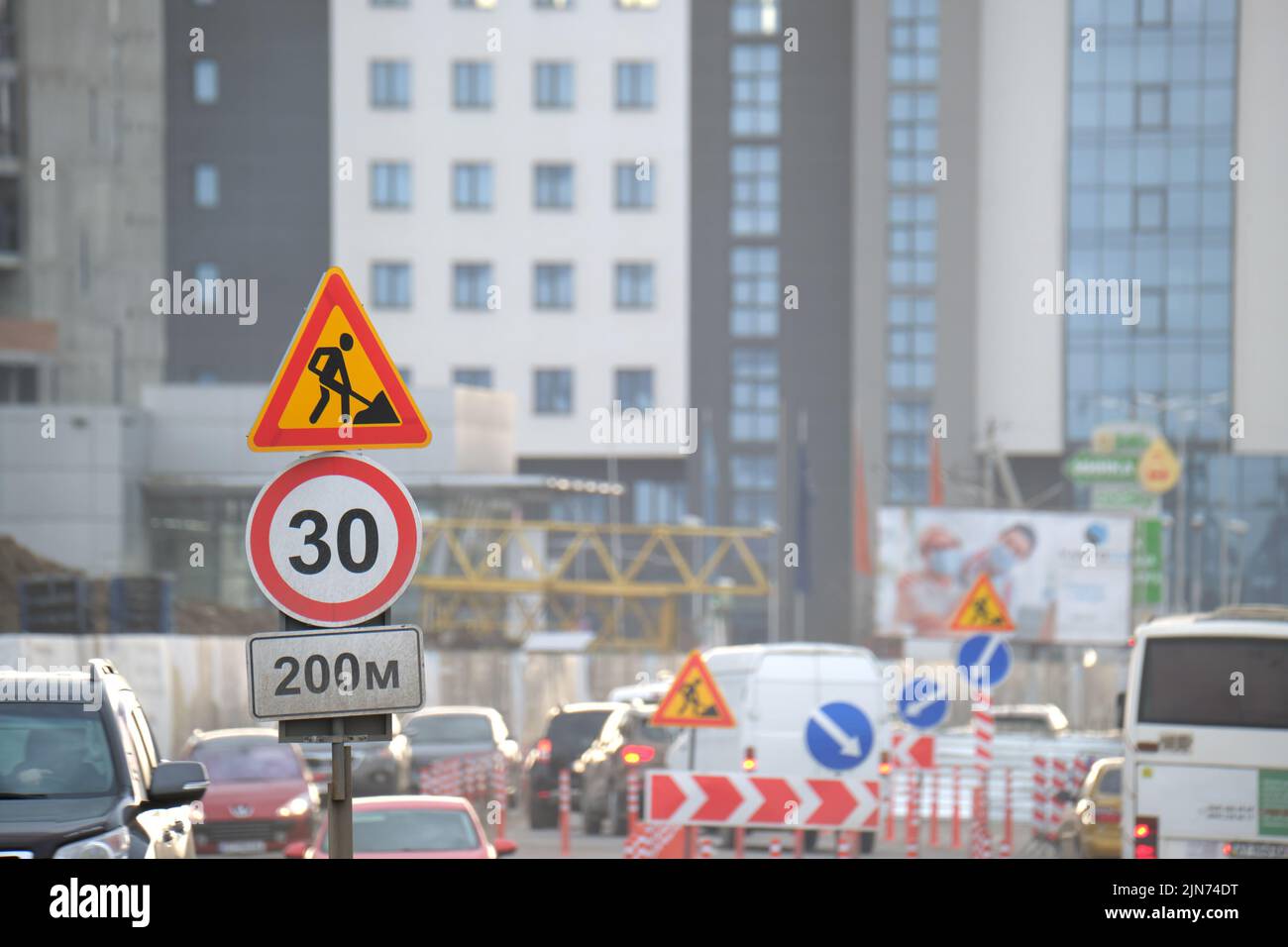 Roadworks warning traffic signs of construction work on city street and ...