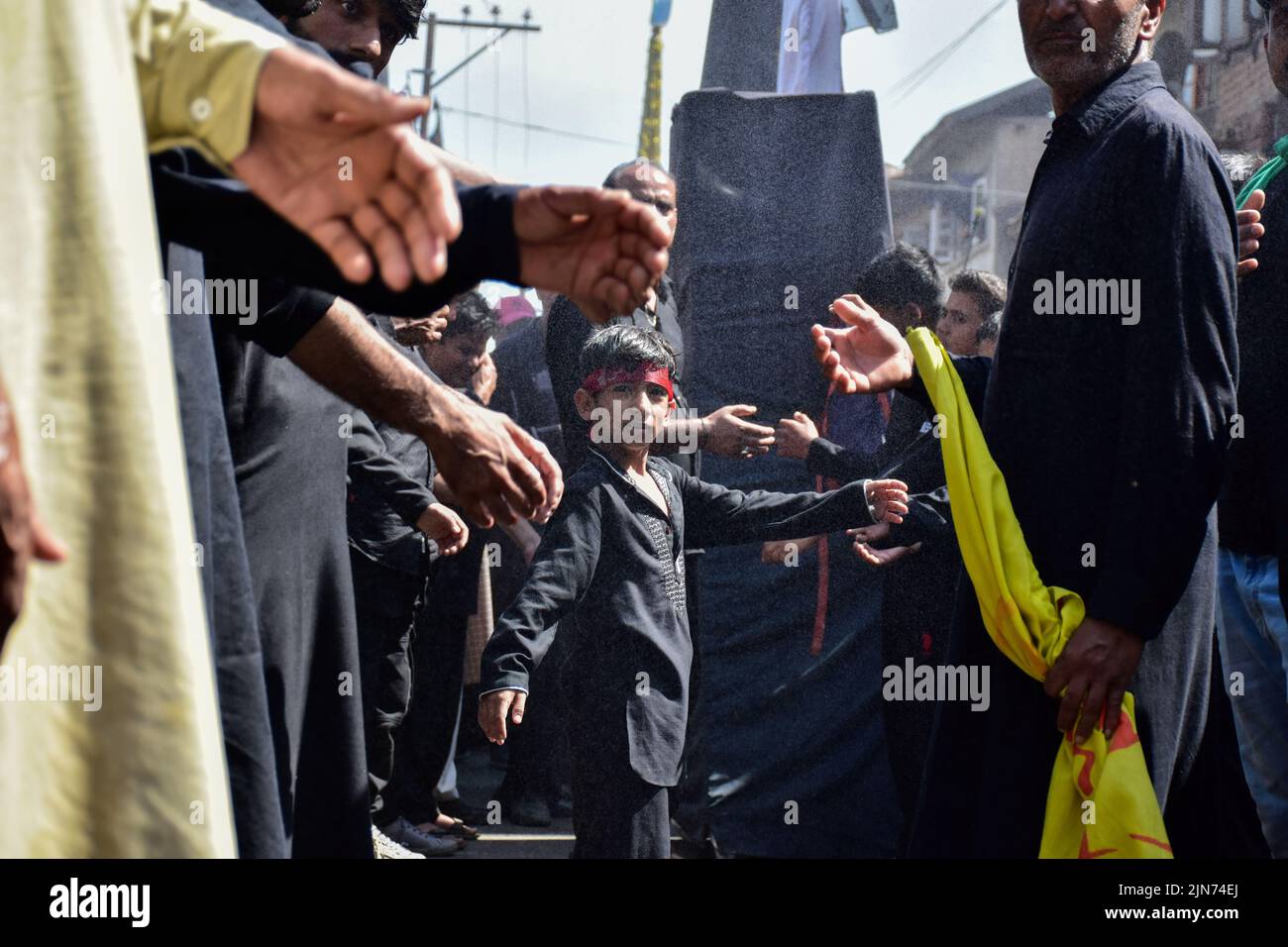 A young Kashmiri Shiite Muslim takes part in a mourning ritual to mark ...