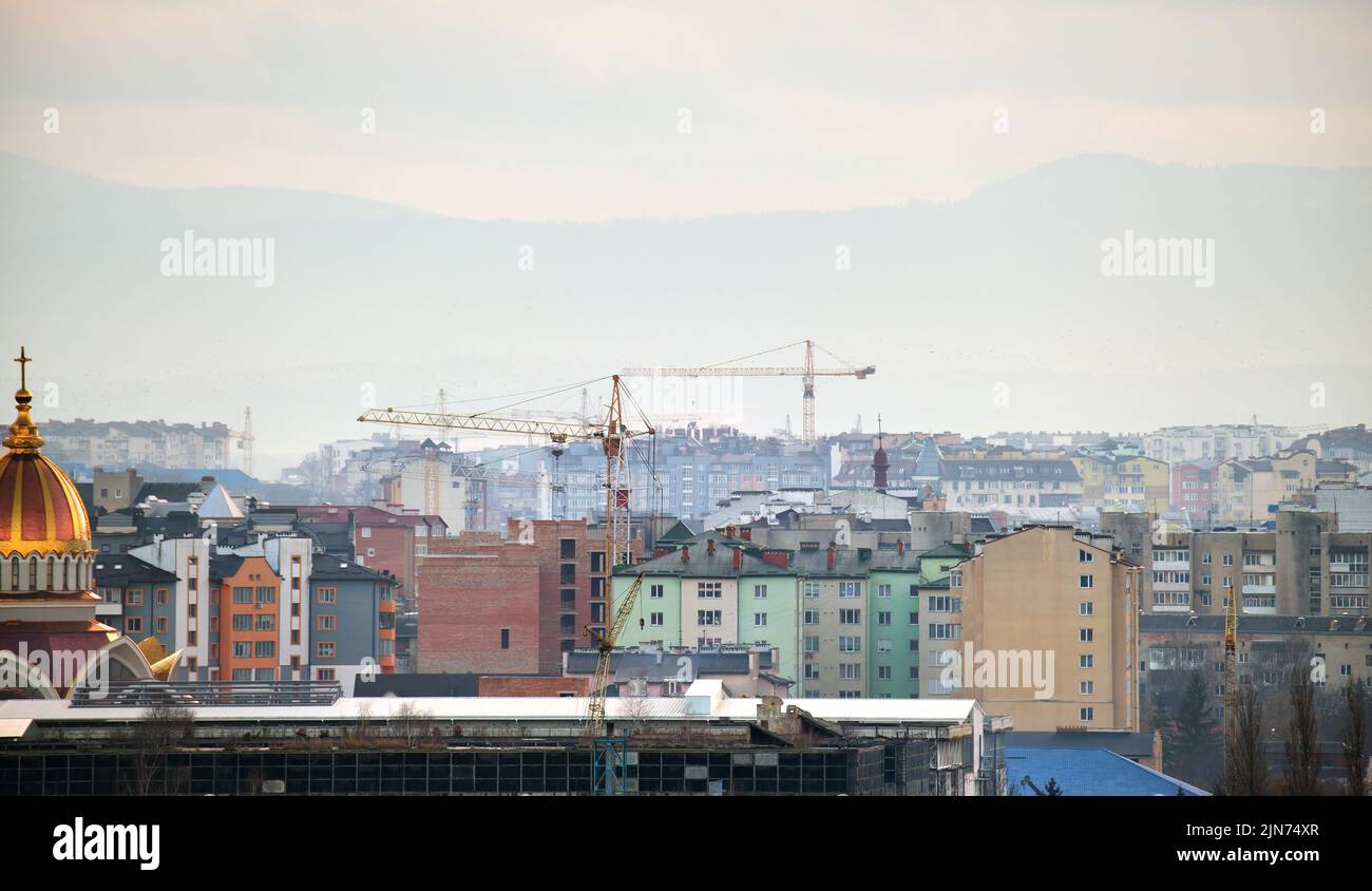 Tower cranes at high residential apartment buildings construction site ...
