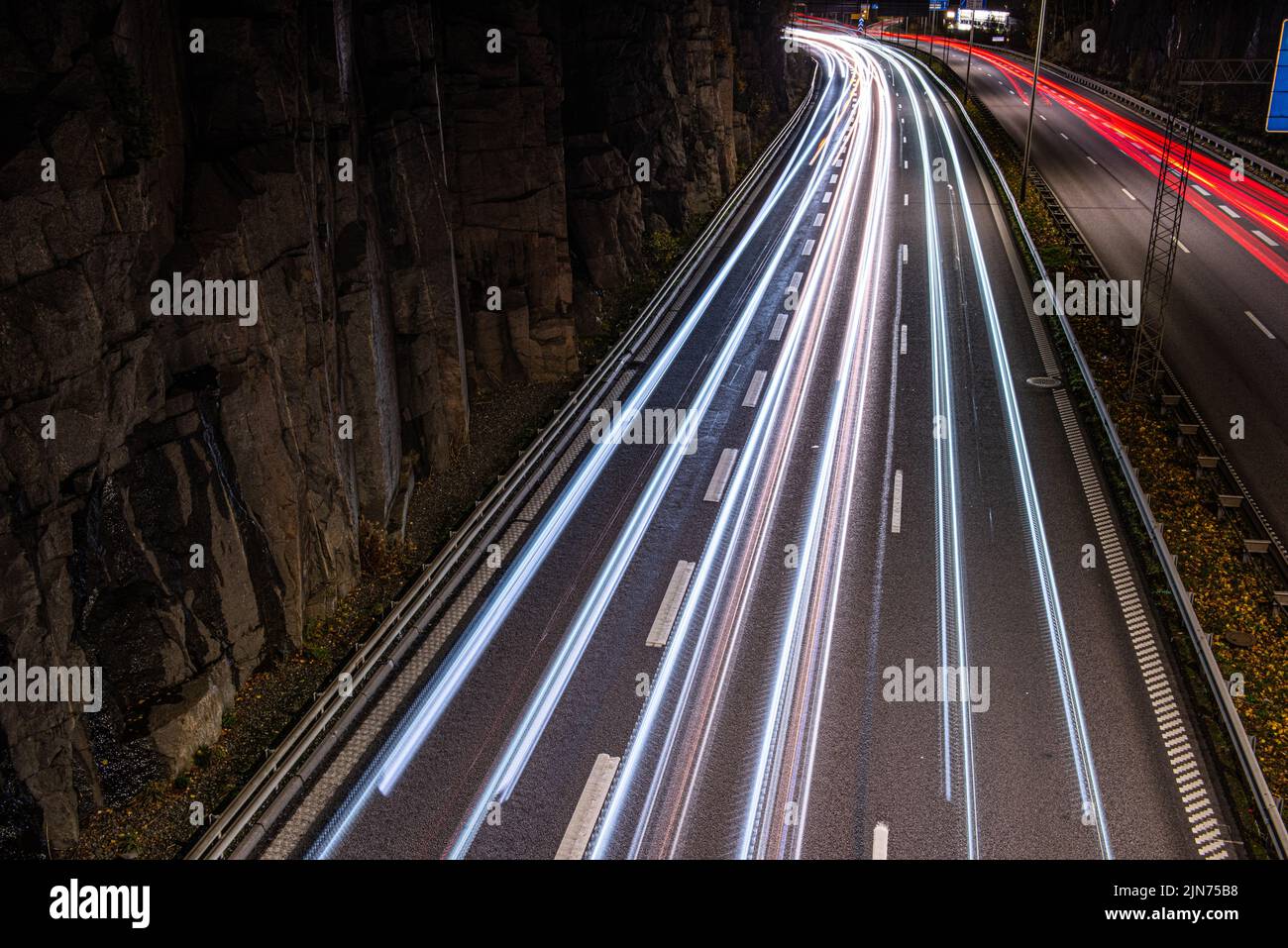 A highway road with light trails of long exposure at night Stock Photo ...