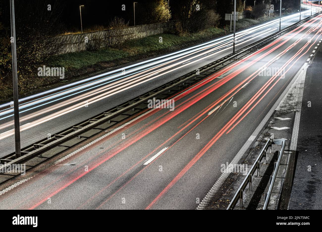 A highway road with light trails of long exposure at night Stock Photo ...