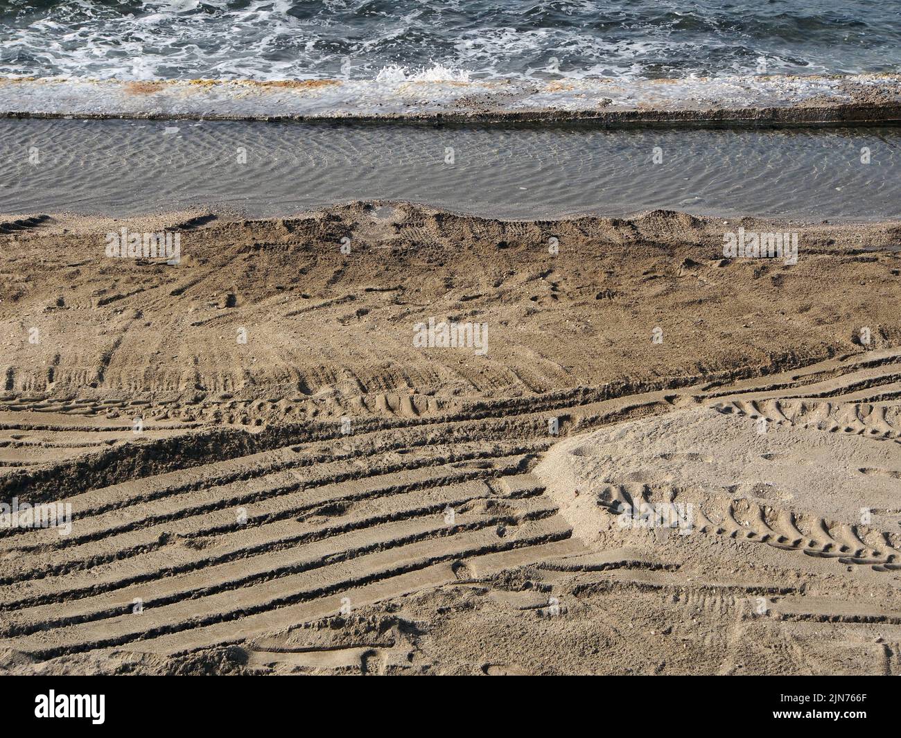 cleaning and flattening the beach with rake. Ecology concept Stock ...