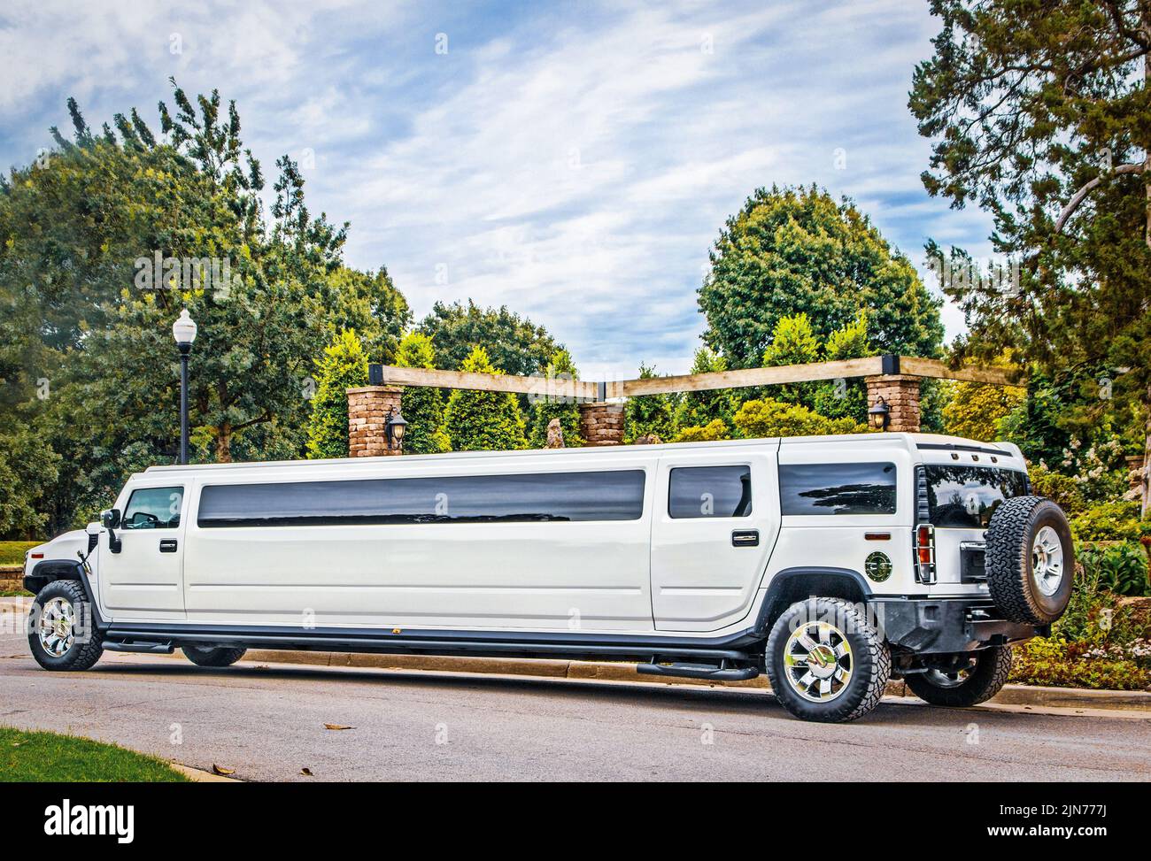White stretch Limousine SUV parked on street in leafy area Stock Photo ...