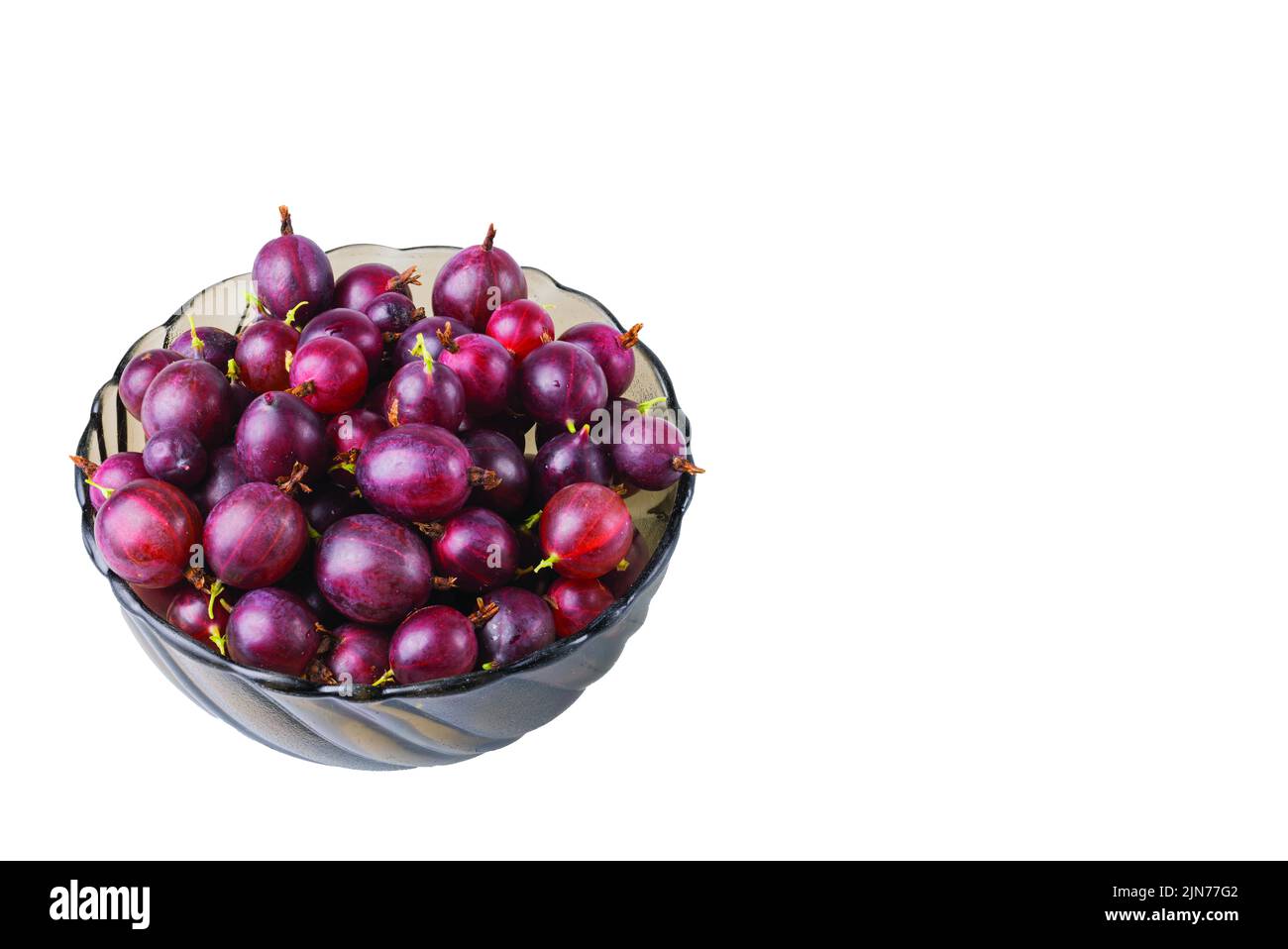 Close up view of bawl with ripe red gooseberries on white background ...