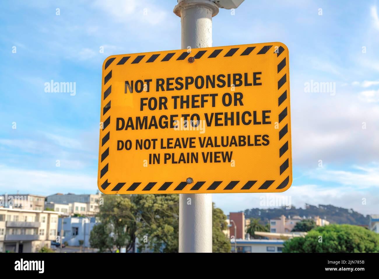 Yellow warning sign on a post in San Francisco, California. Signage ...