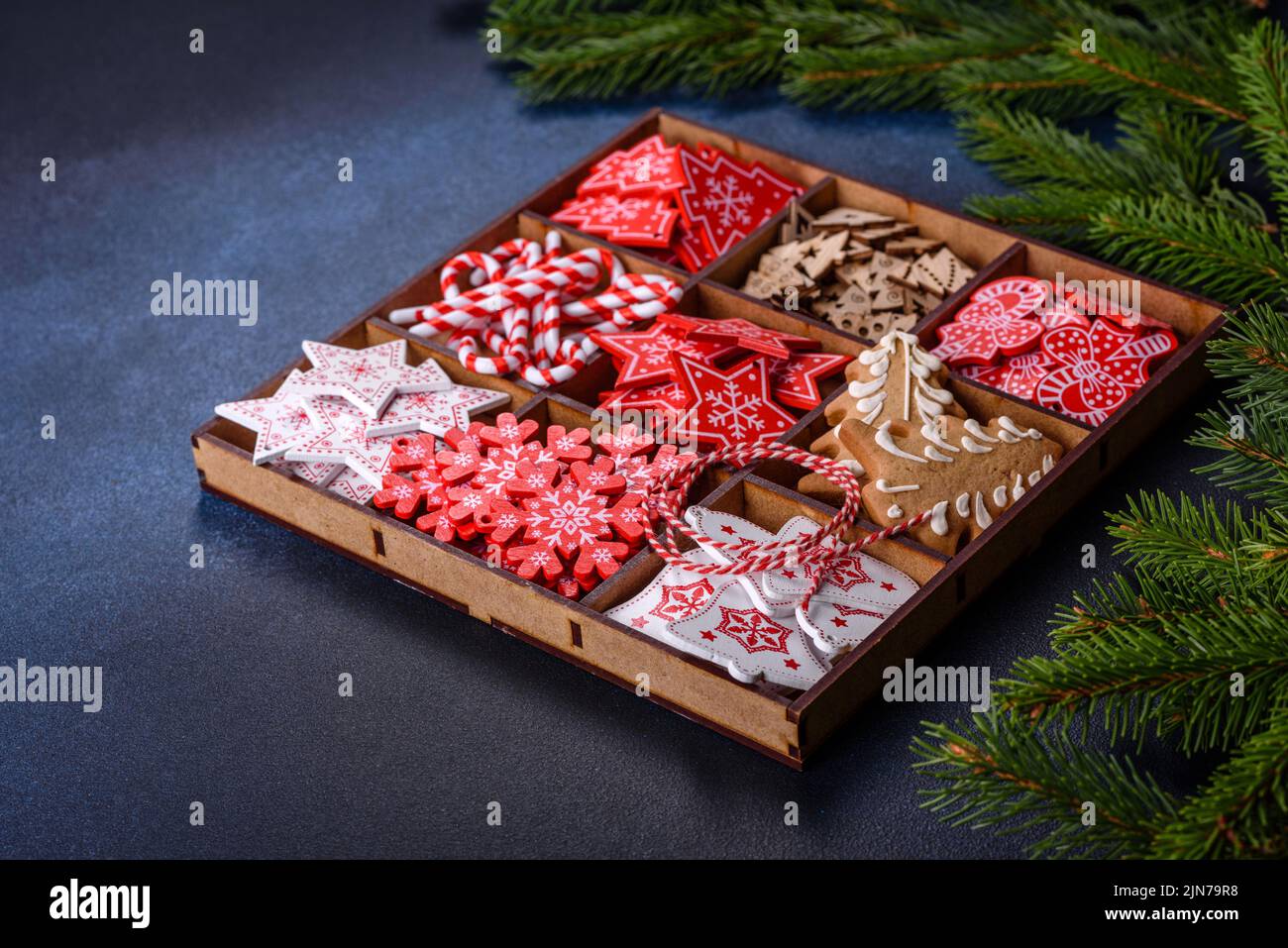 Christmas toys in white and red in a wooden sectional box against a ...